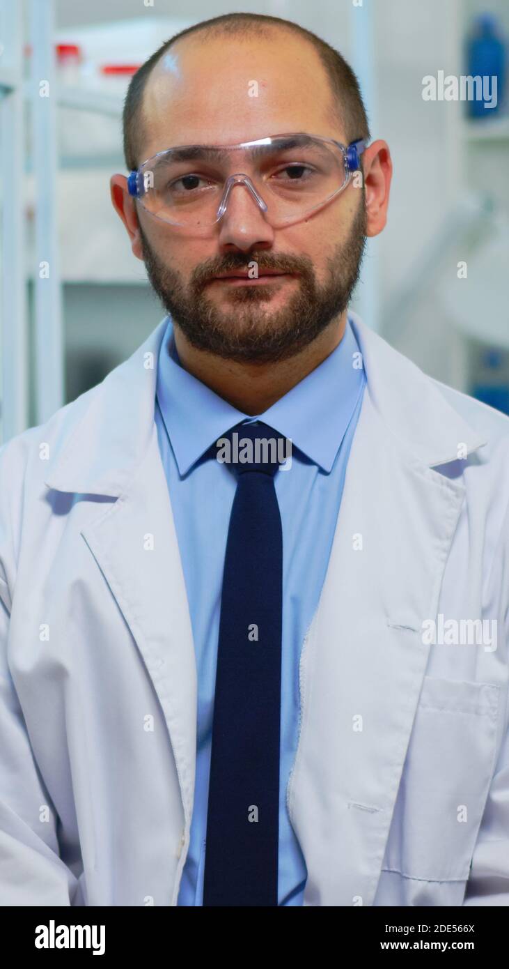 Tired doctor looking exhausted at camera in modern equipped lab ...