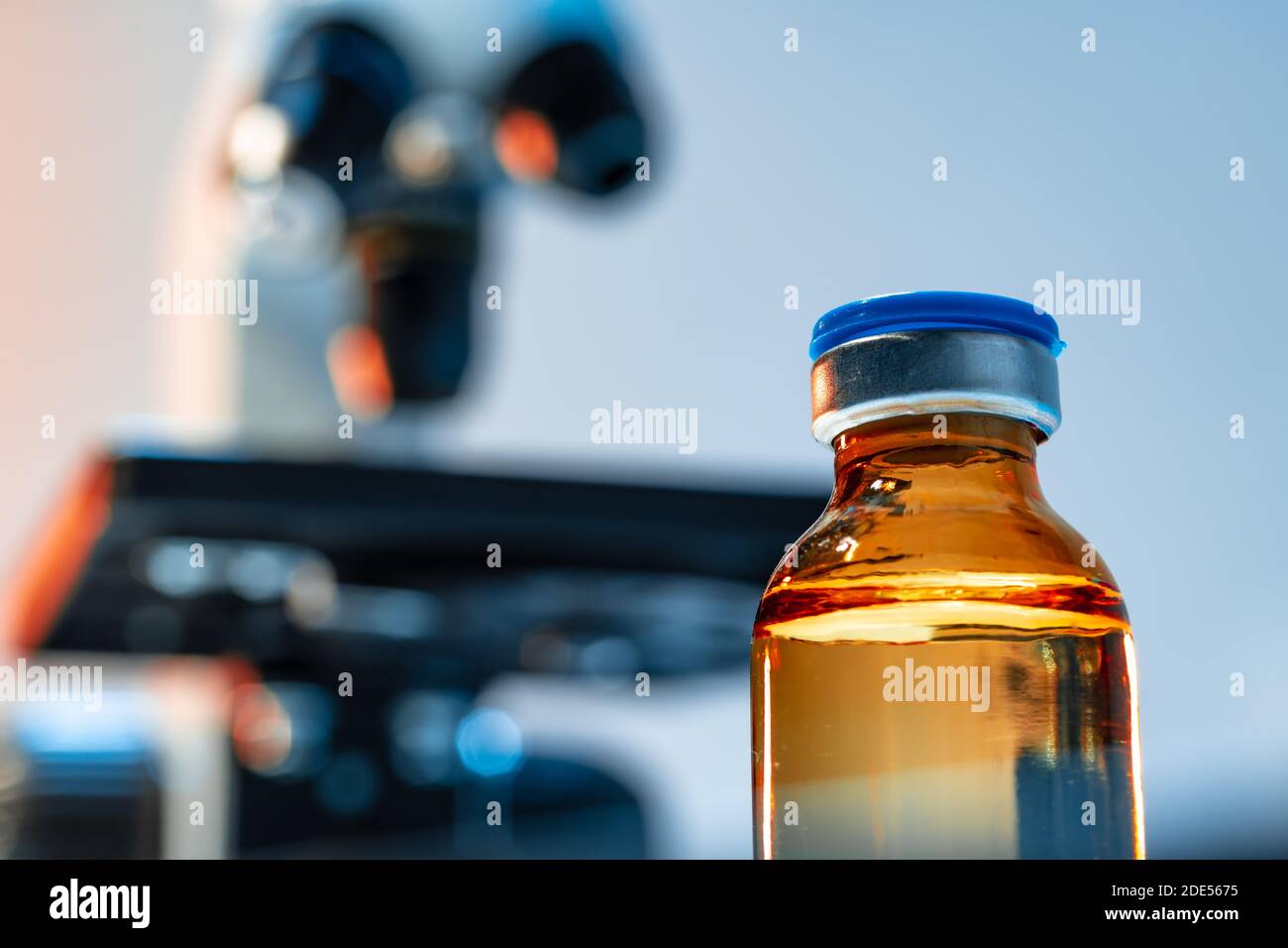 Medical vial with medication near microscope photo Stock Photo - Alamy