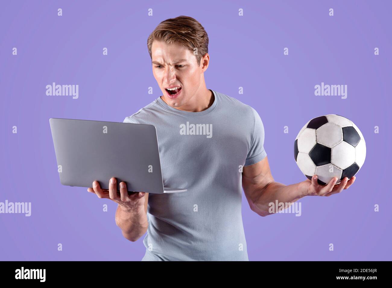 Young guy disappointed at his soccer team defeat, watching football ...