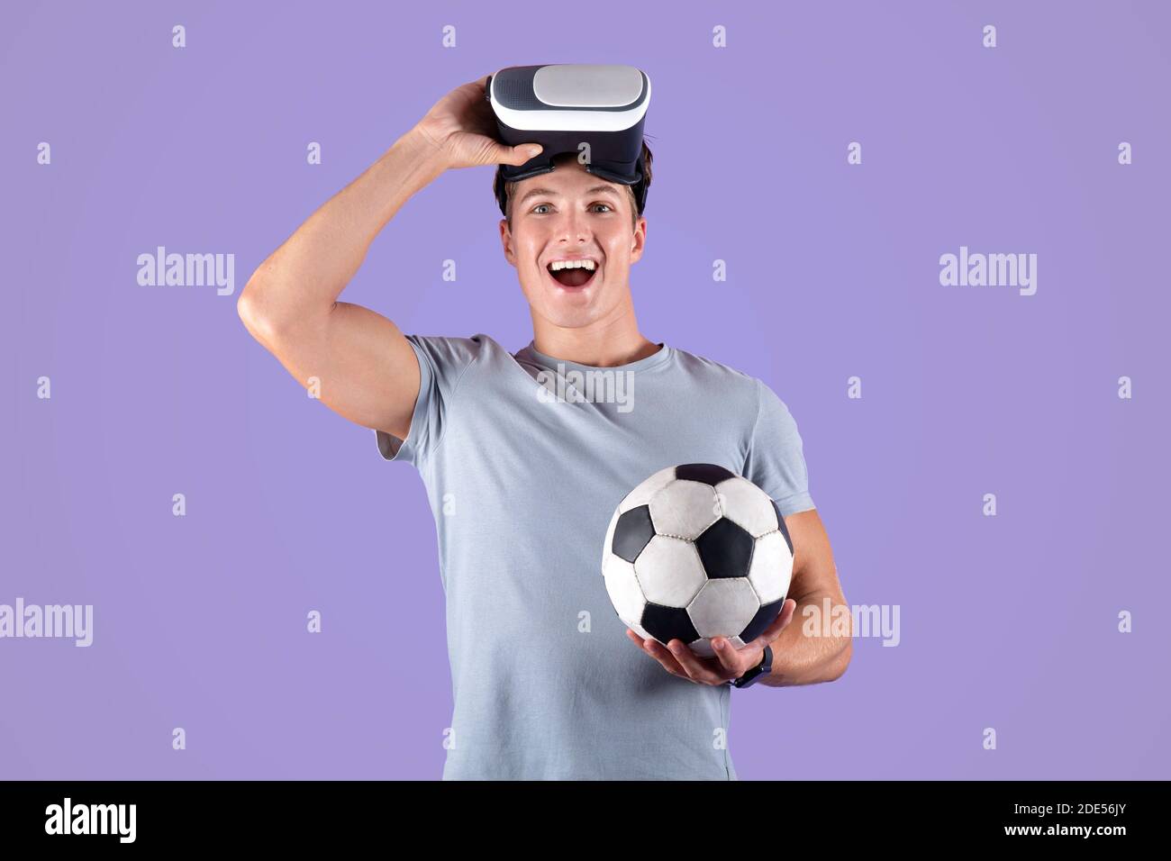 Exercising with virtual reality concept. Young athletic guy in VR ...
