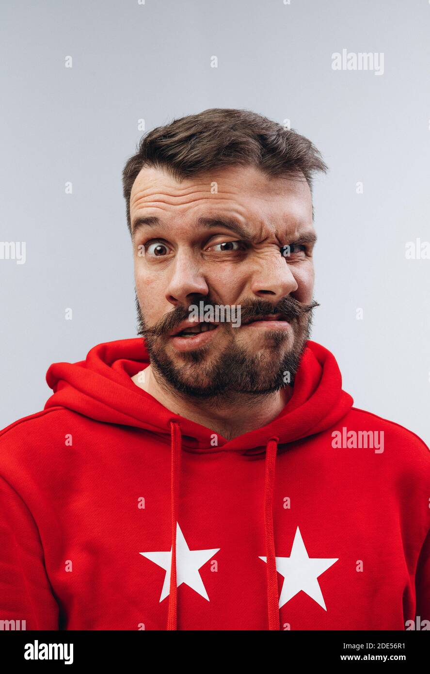 Calm and crazy. Young man with dual emotions combination on face ...