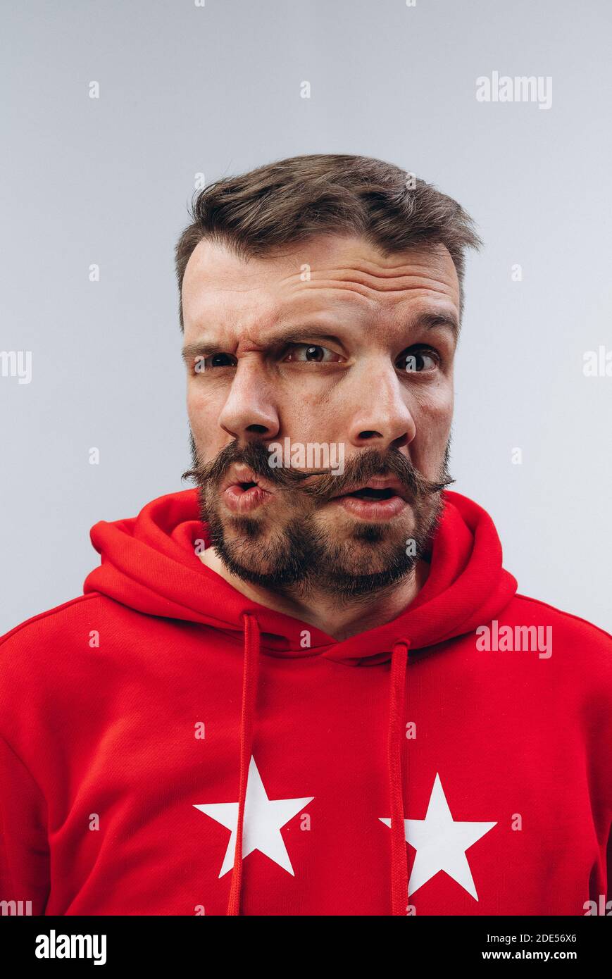 Asking, wondered. Young man with dual emotions combination on face ...