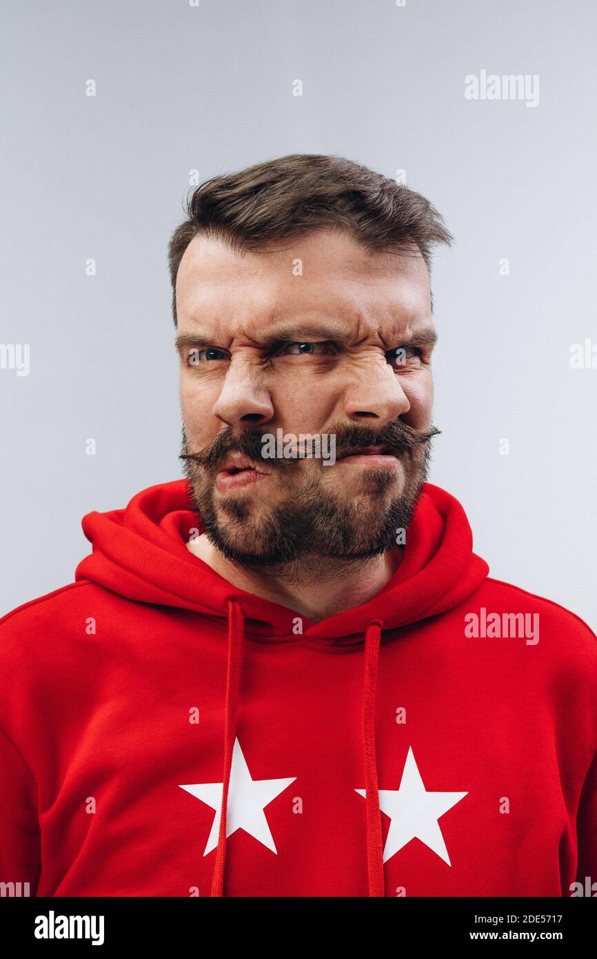 Disguasted. Young man with dual emotions combination on face isolated ...