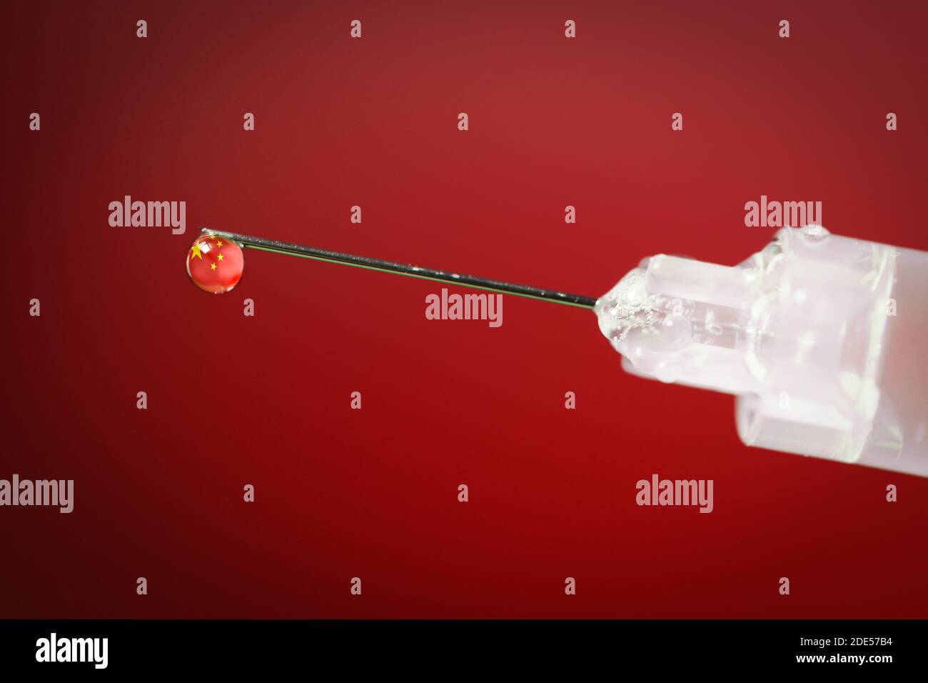 Close-up of a drop in a syringe with the Chinese flag waving inside ...