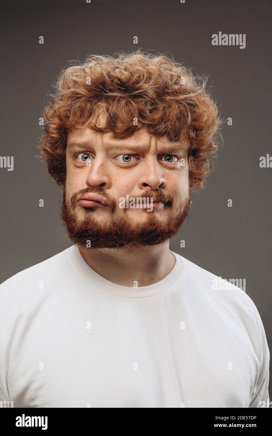 Cute, thoughtful. Young man with dual emotions combination on face ...