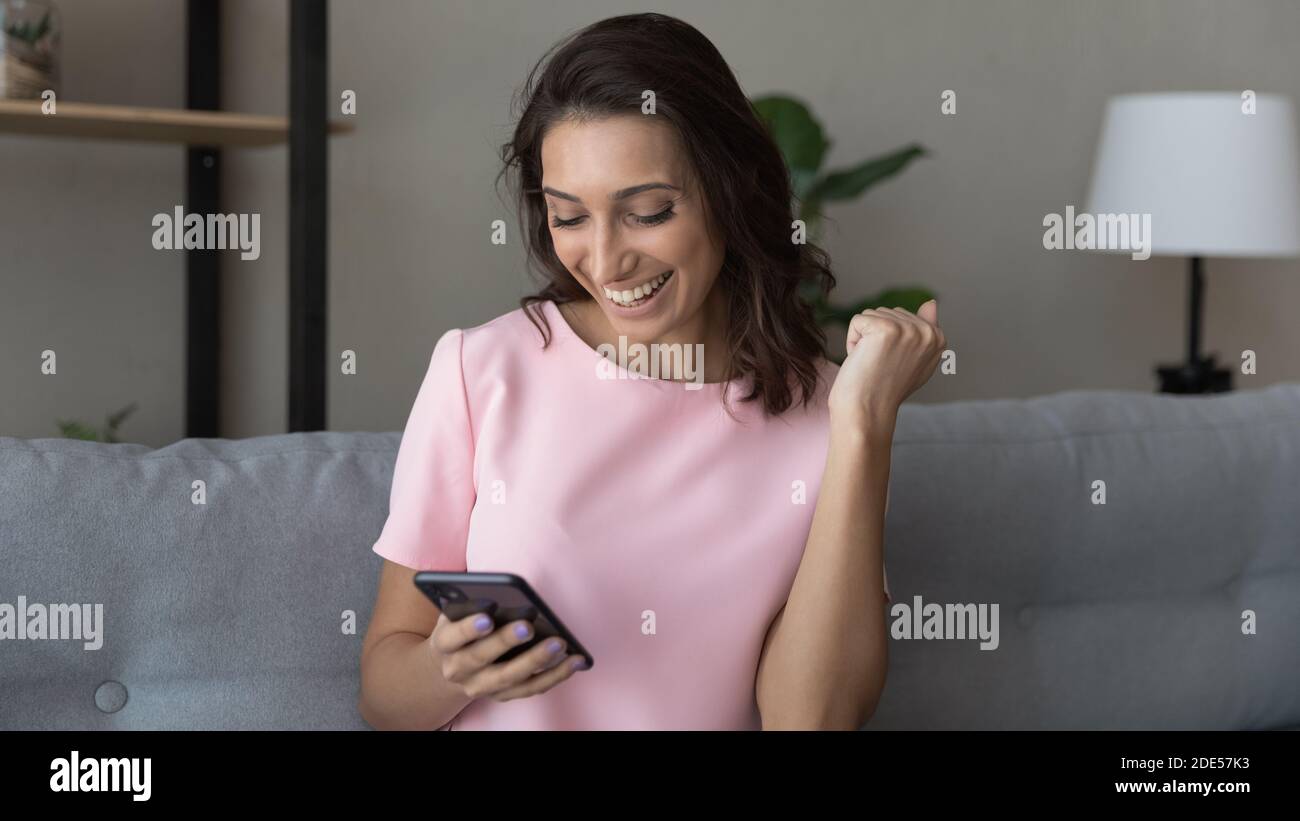 Happy young indian arabic woman reading email with good news Stock ...