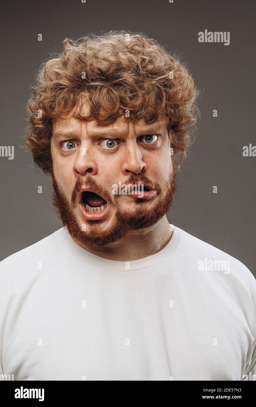 Gremaces, shocked. Young man with dual emotions combination on face ...