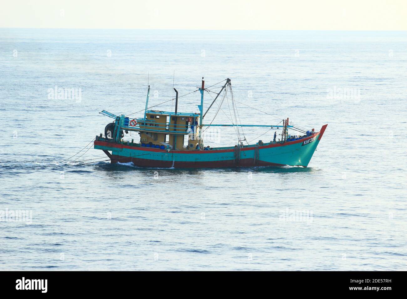 Traditional Myanmarese / Burmese wooden hulled fishing boat trawling in ...