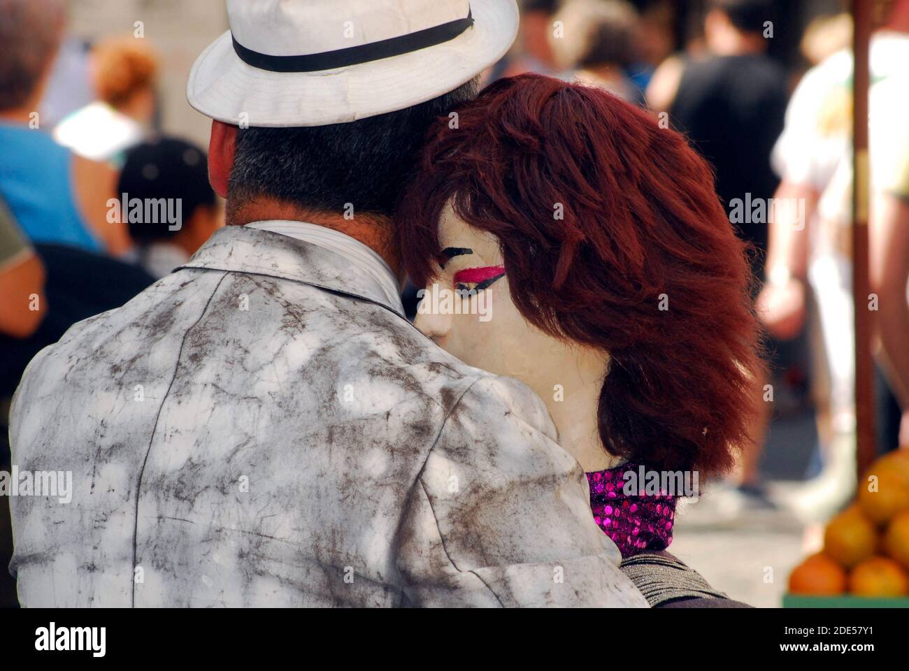 male dancer with a female puppet dancing Tango in public space in ...