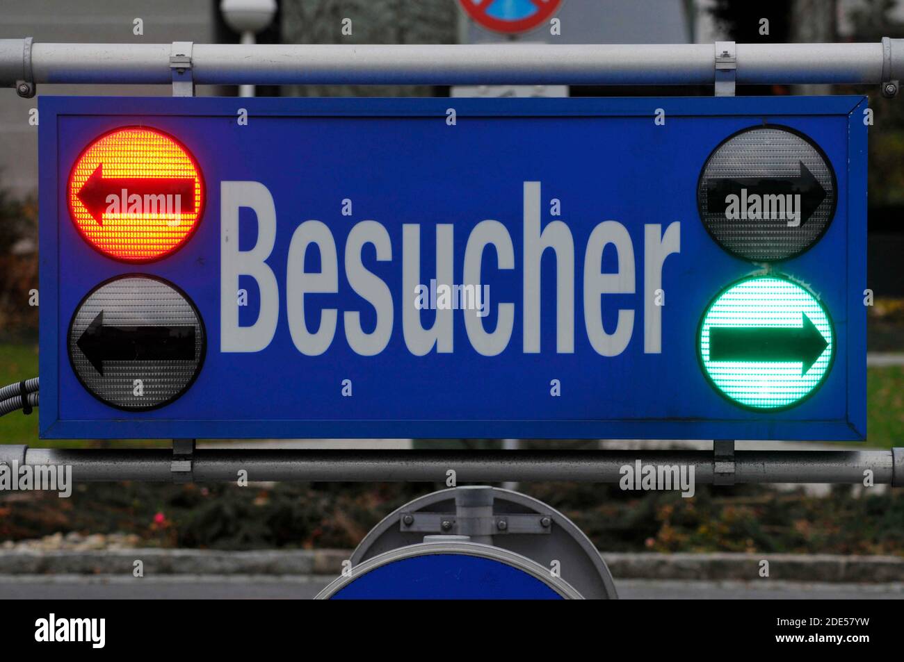 blue Besucher (visitor) road sign with green and red direction arrows ...