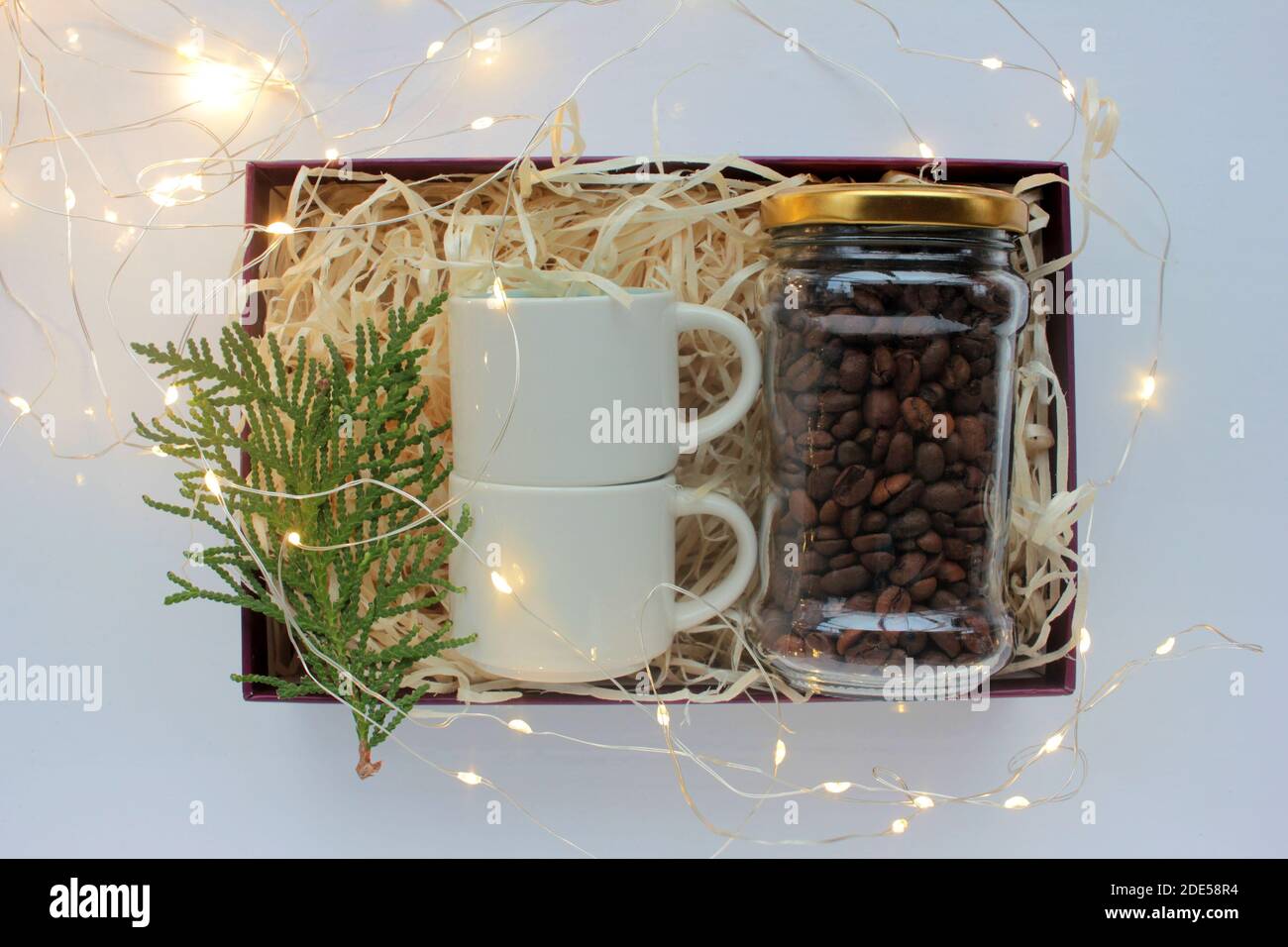 Christmas gift basket with coffee beans in glass jar and two espresso ...