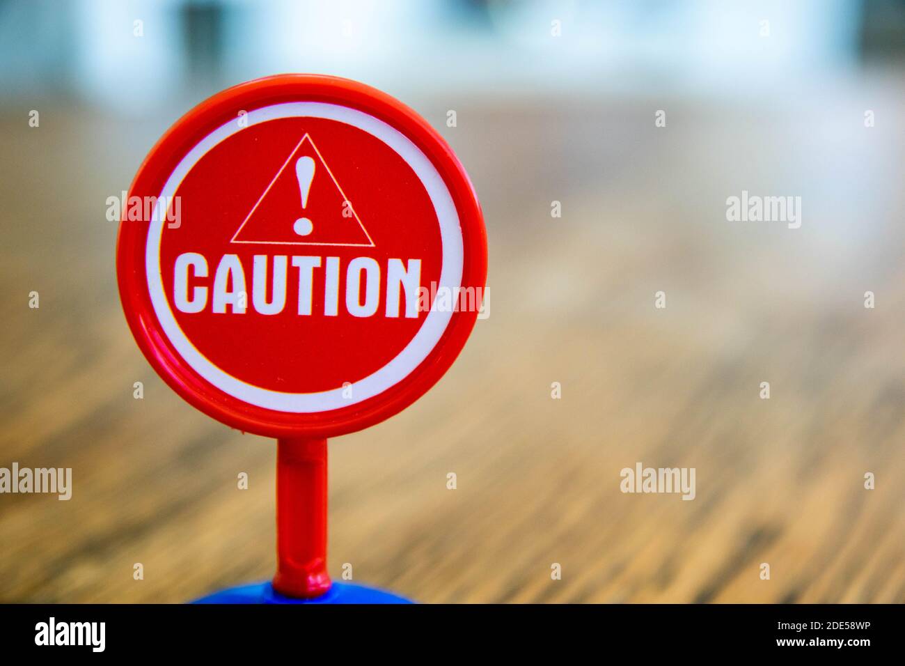 Isolated plastic toy warning sign - Caution. Men at work, danger ahead ...