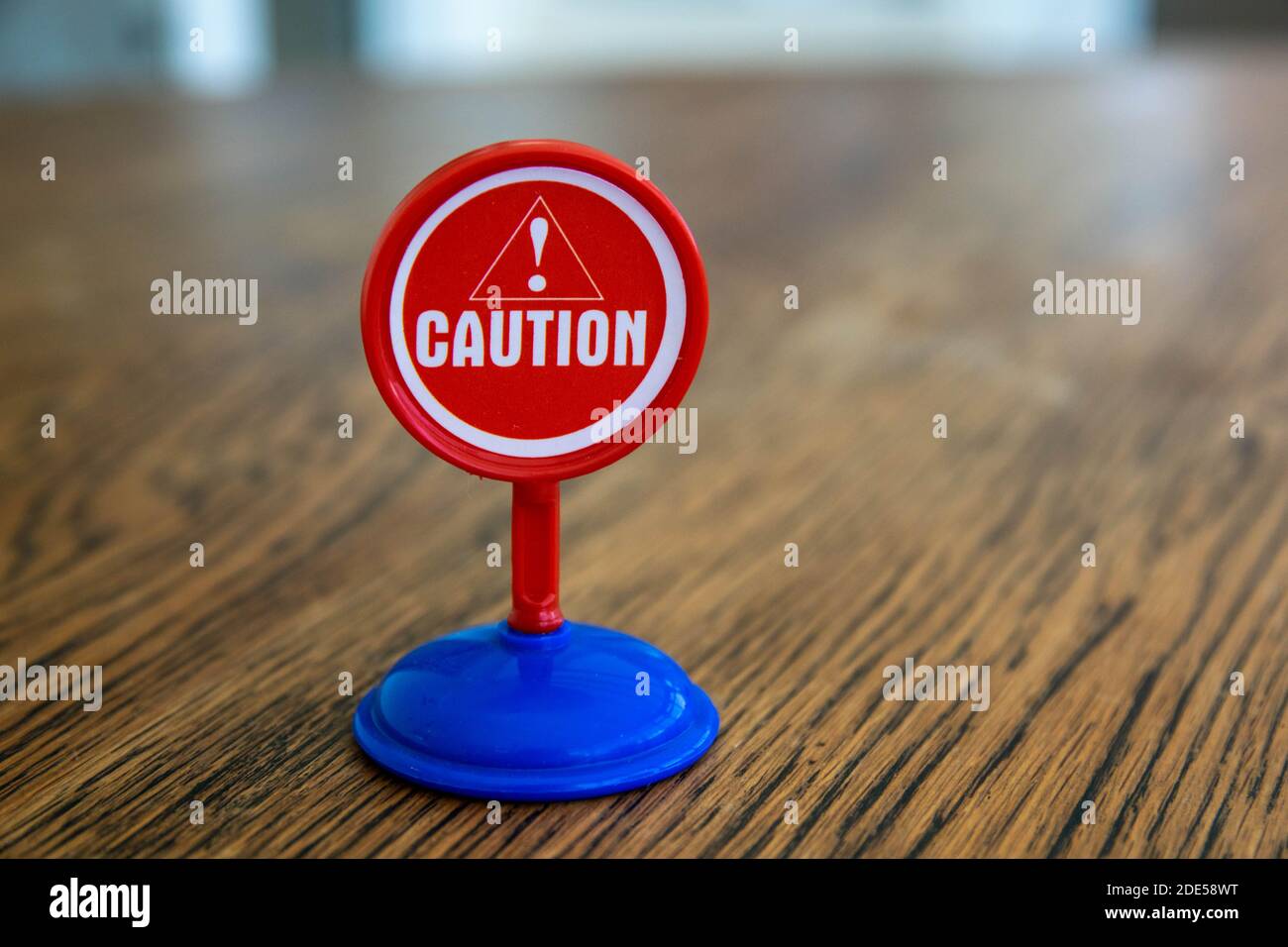 Isolated plastic toy warning sign - Caution. Men at work, danger ahead ...