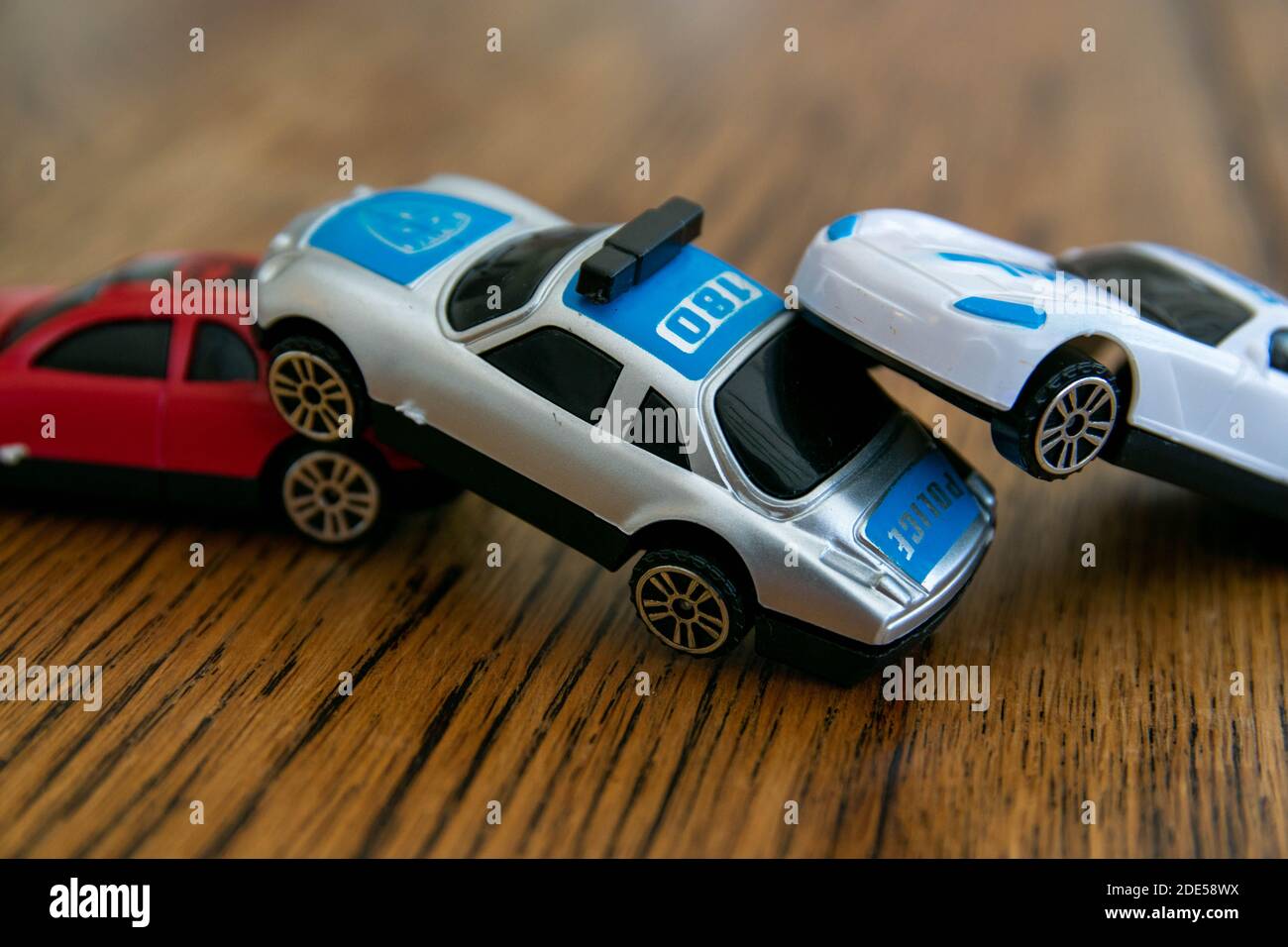 Plastic toys representing a car collision. 3 car pile up, crash, damage ...
