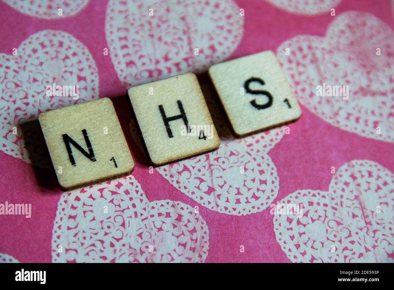 Old worn vintage wooden textured cubes spelling out NHS, the British ...