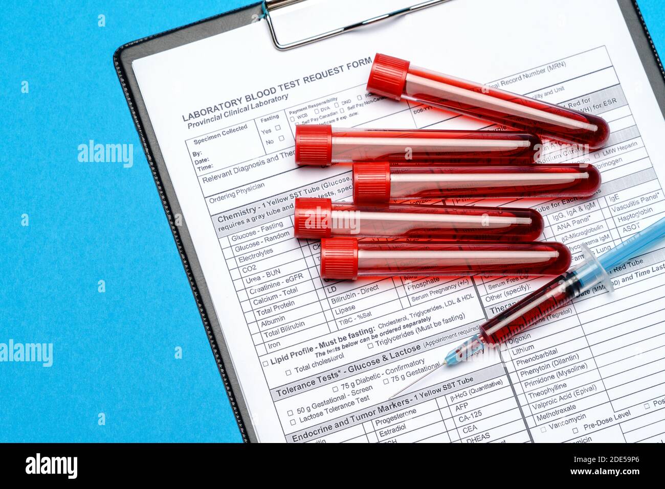 Clipboard with paper blank form with blood test tubes on blue ...