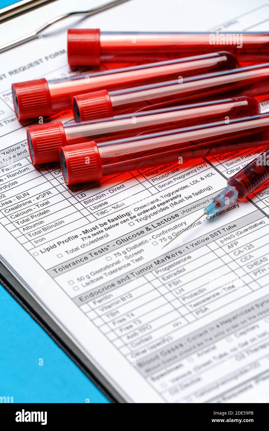 Clipboard with paper blank form with blood test tubes on blue ...