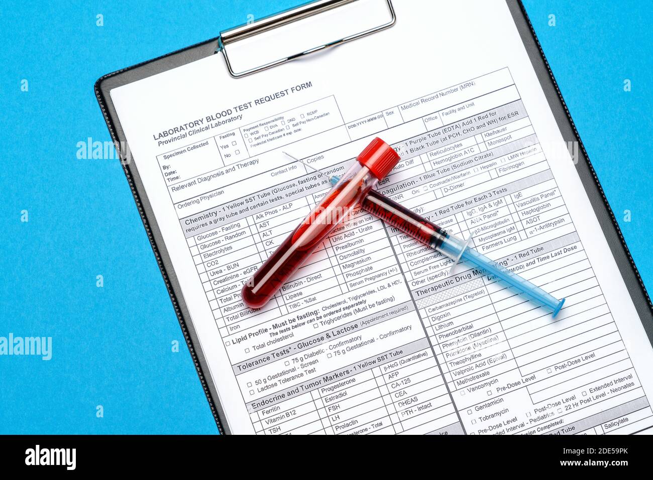 Clipboard with paper blank form with blood test tubes on blue ...