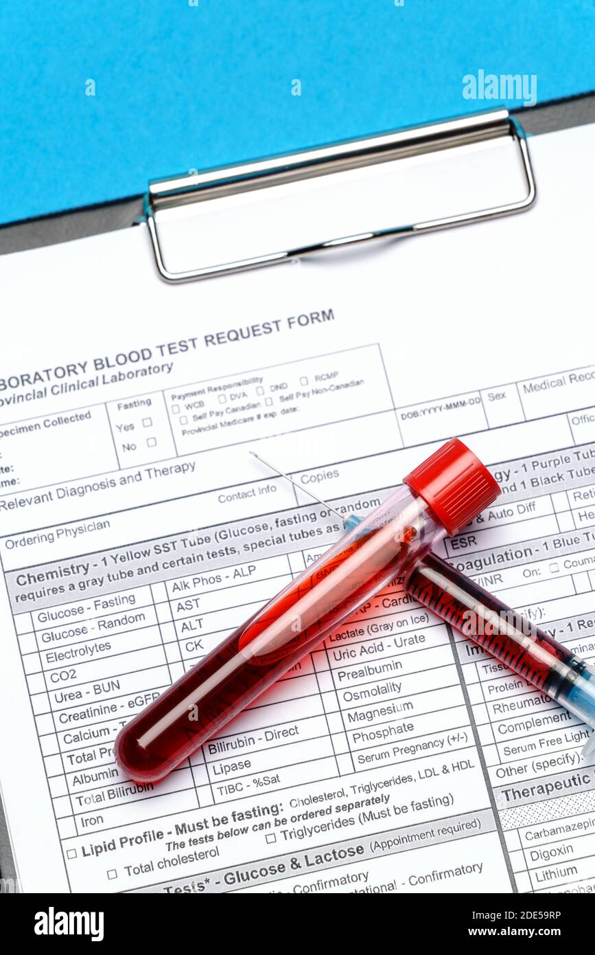 Clipboard with paper blank form with blood test tubes on blue ...