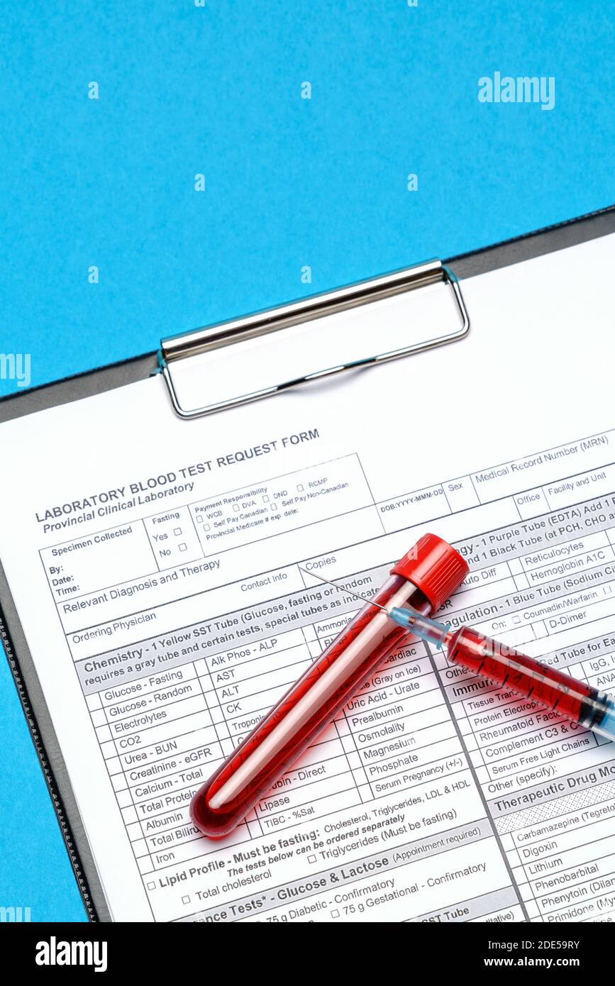 Clipboard with paper blank form with blood test tubes on blue ...