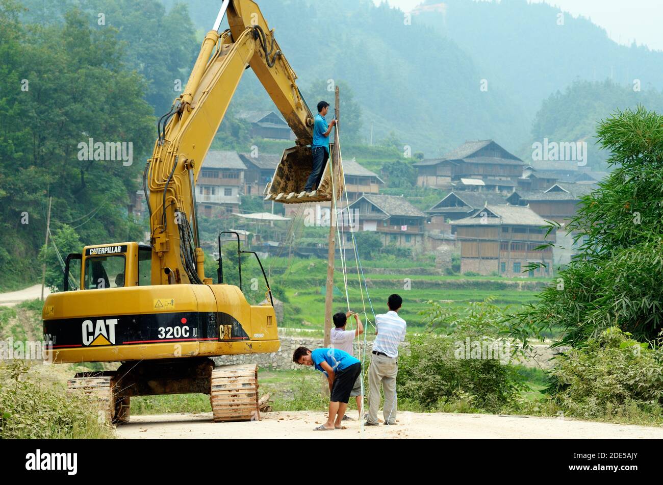 ZHAOXING DONG, CHINA - JUNE 21, 2012: Chinese workers repairing outdoor ...