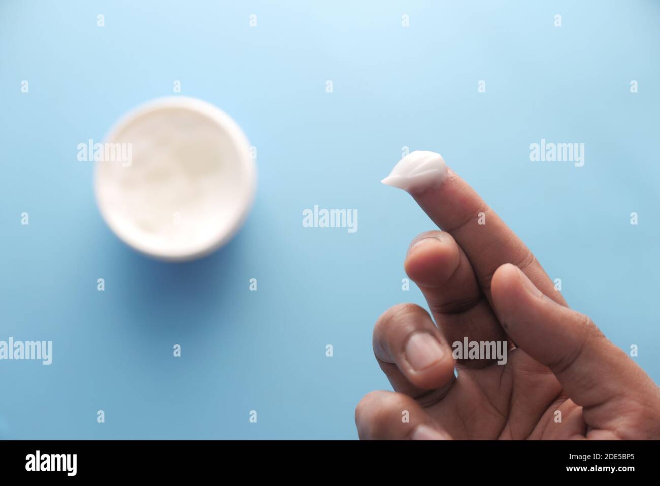 man applying beauty cream onto skin at home top view Stock Photo - Alamy