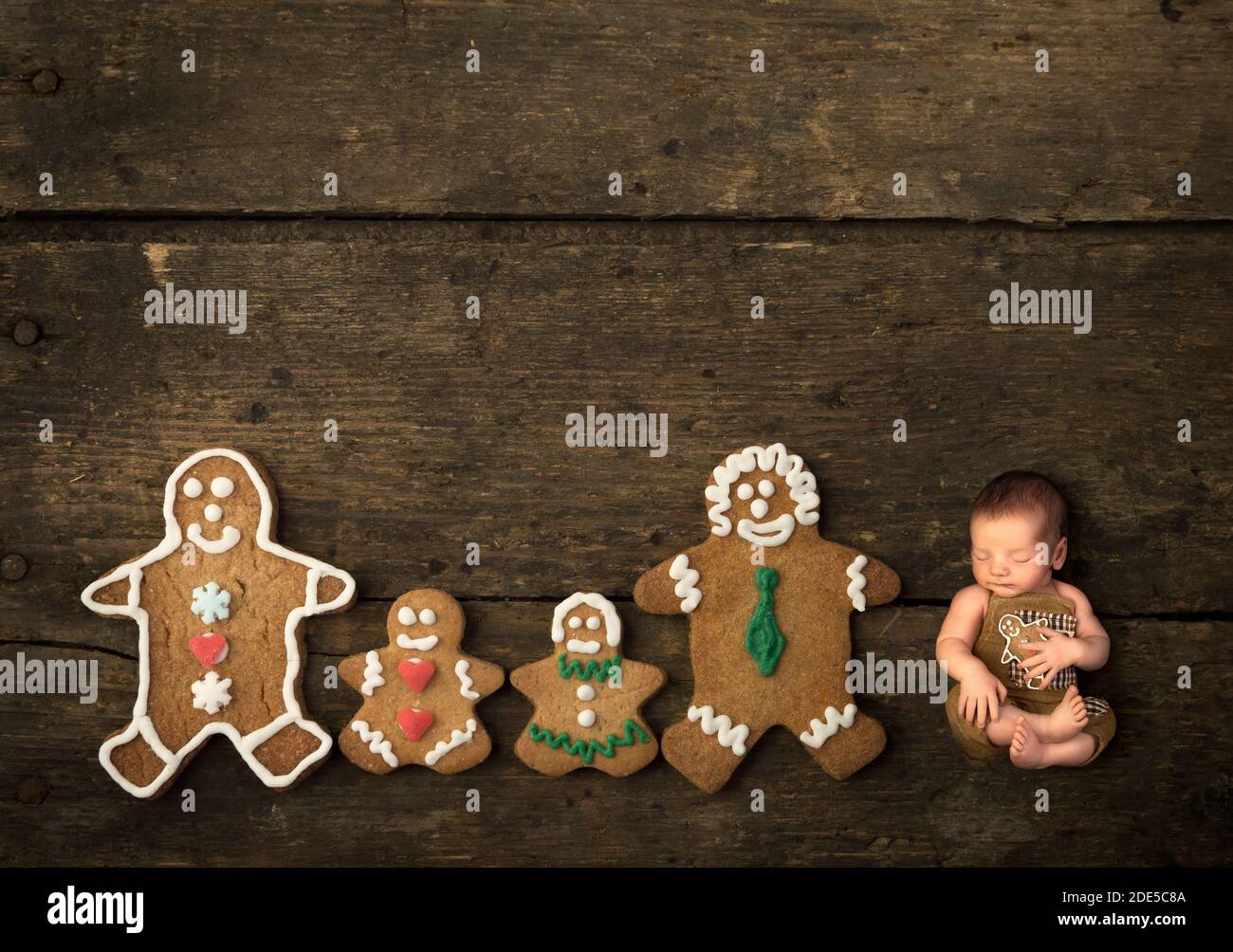 Family of gingerbread men with a real baby in gingerbread outfit Stock ...