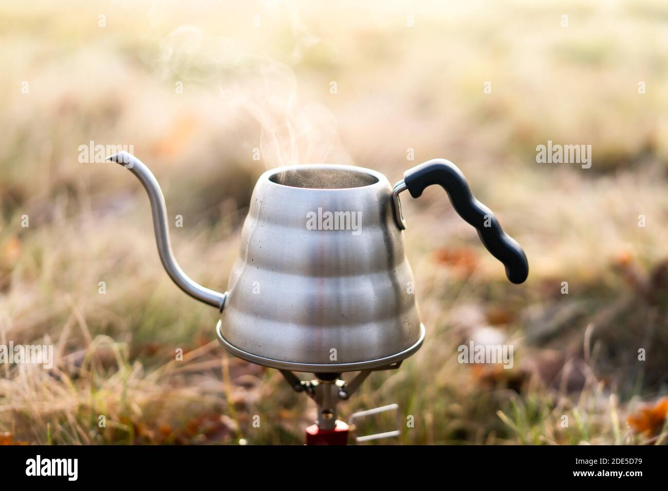 Boiling water for coffee on the meadow Stock Photo - Alamy