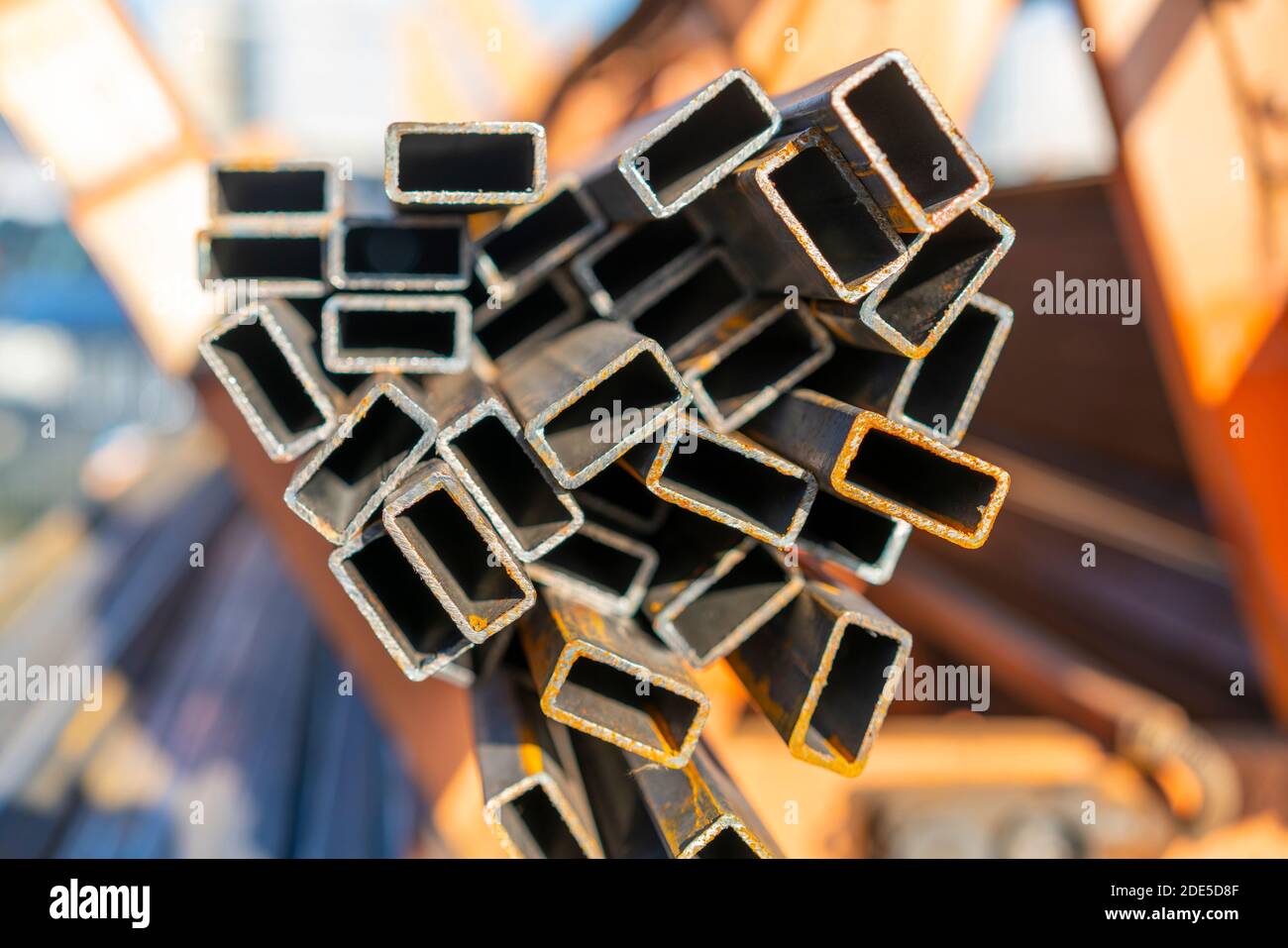 stack of steel pipe and metal beams on rack. metal pipes, profiles ...