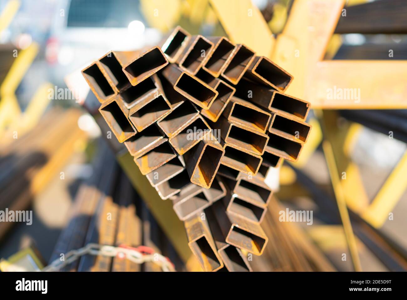 stack of steel pipe and metal beams on rack. metal pipes, profiles ...