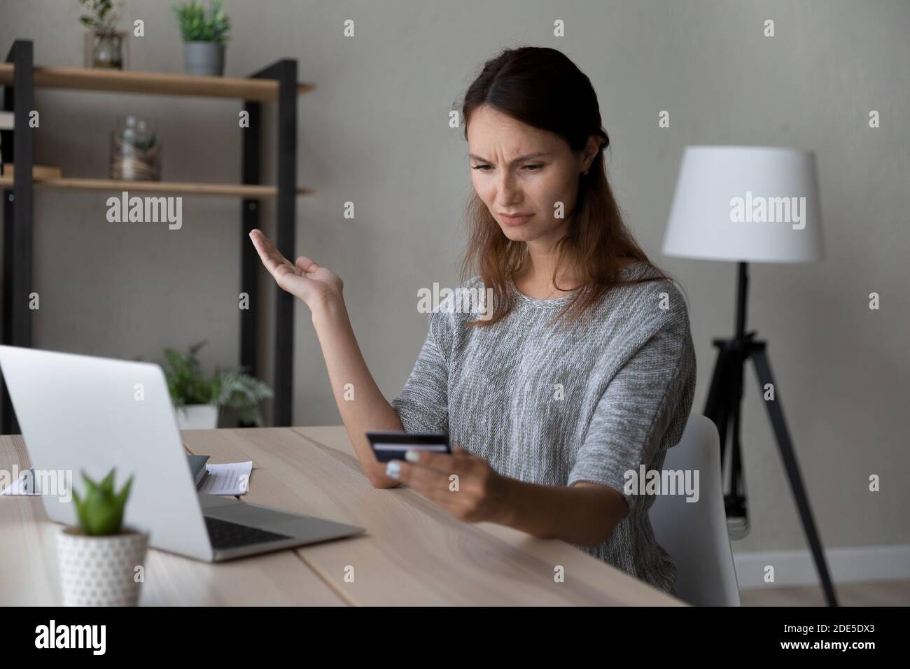Confused young woman stressed by financial payment mistake Stock Photo ...