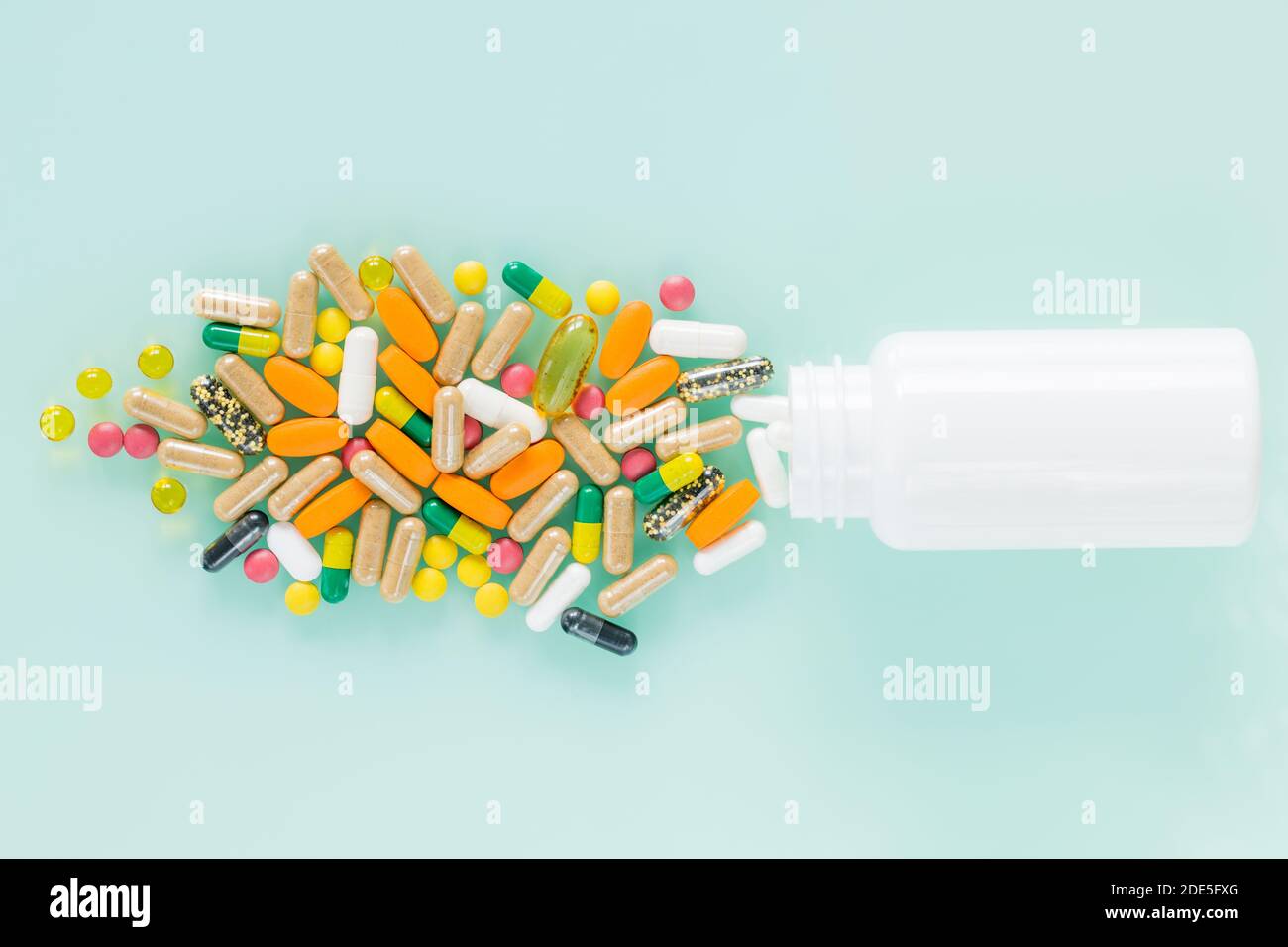 colorful medications spilled out of box, concept for health or ...