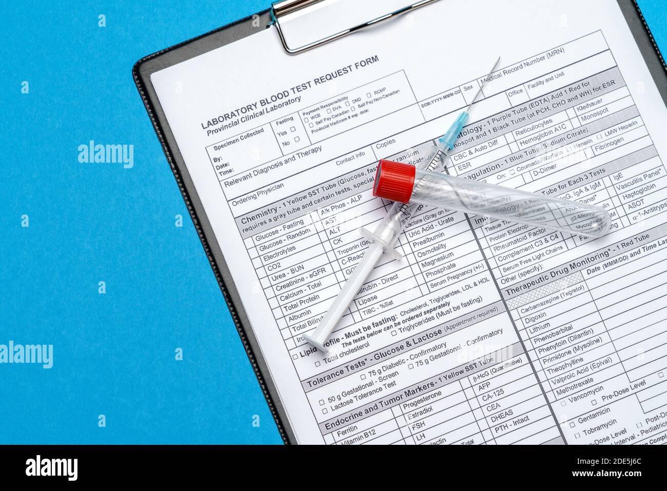 Clipboard with paper blank form with blood test tubes on blue ...