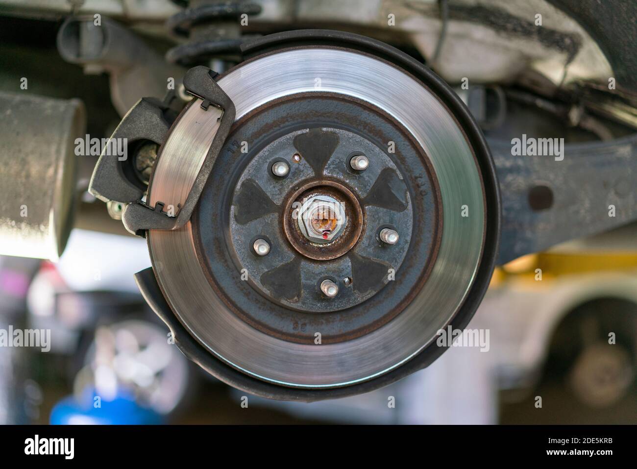 The hub of a wheel in a car service. Suspended car with no wheels ...