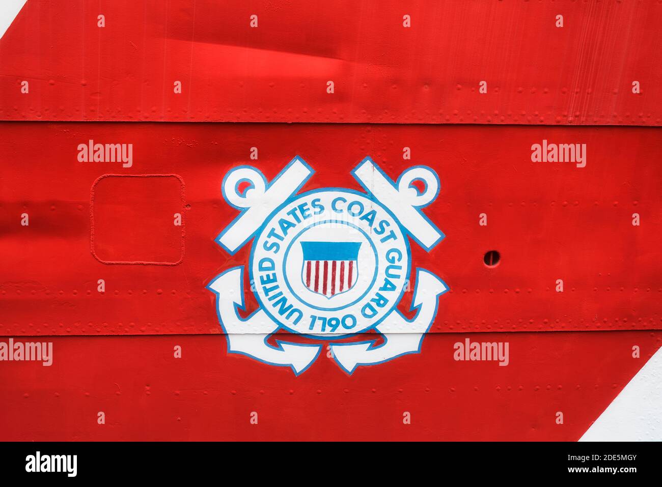 The iconic coast guard symbol on a red banner on the outside of a ships ...