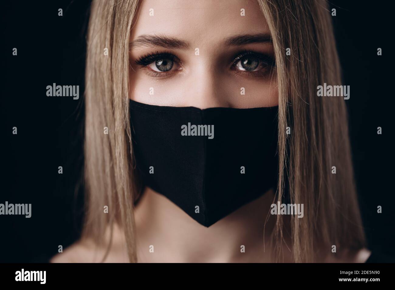 Woman in mask standing with tears in eyes Stock Photo - Alamy