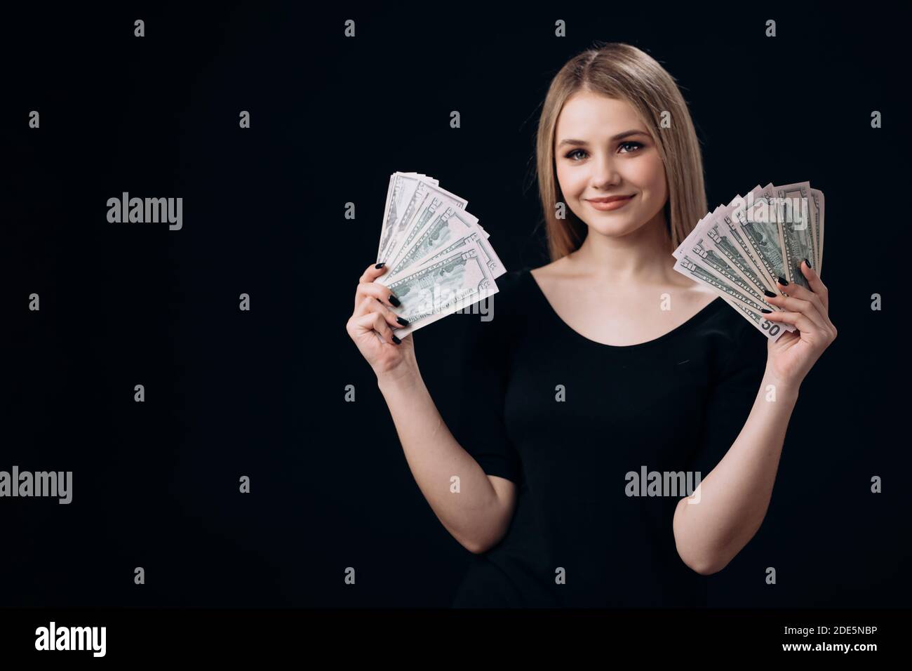 Happy female holding money hi-res stock photography and images - Alamy