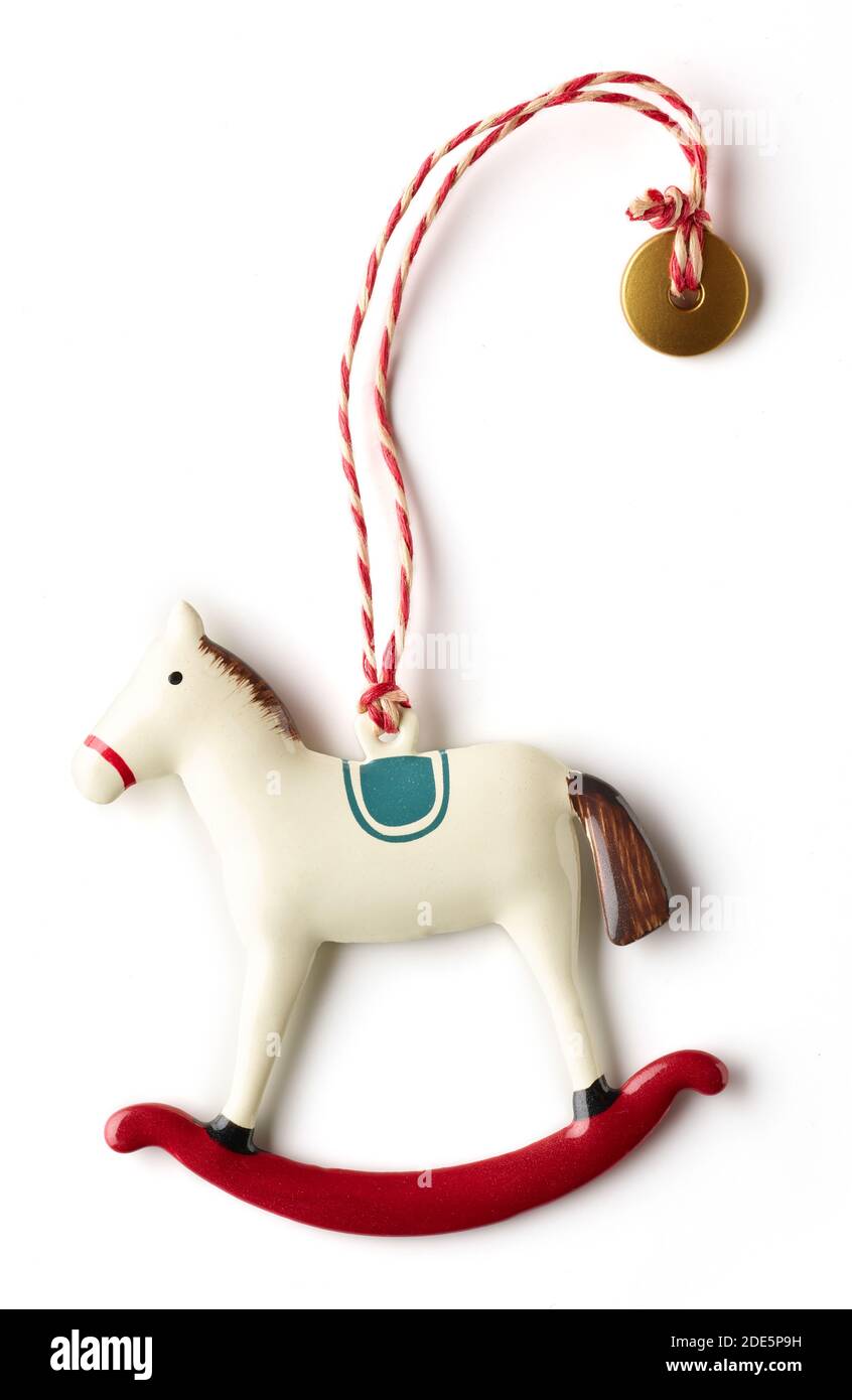 Christmas rocking horse decoration with golden ribbon isolated on white ...