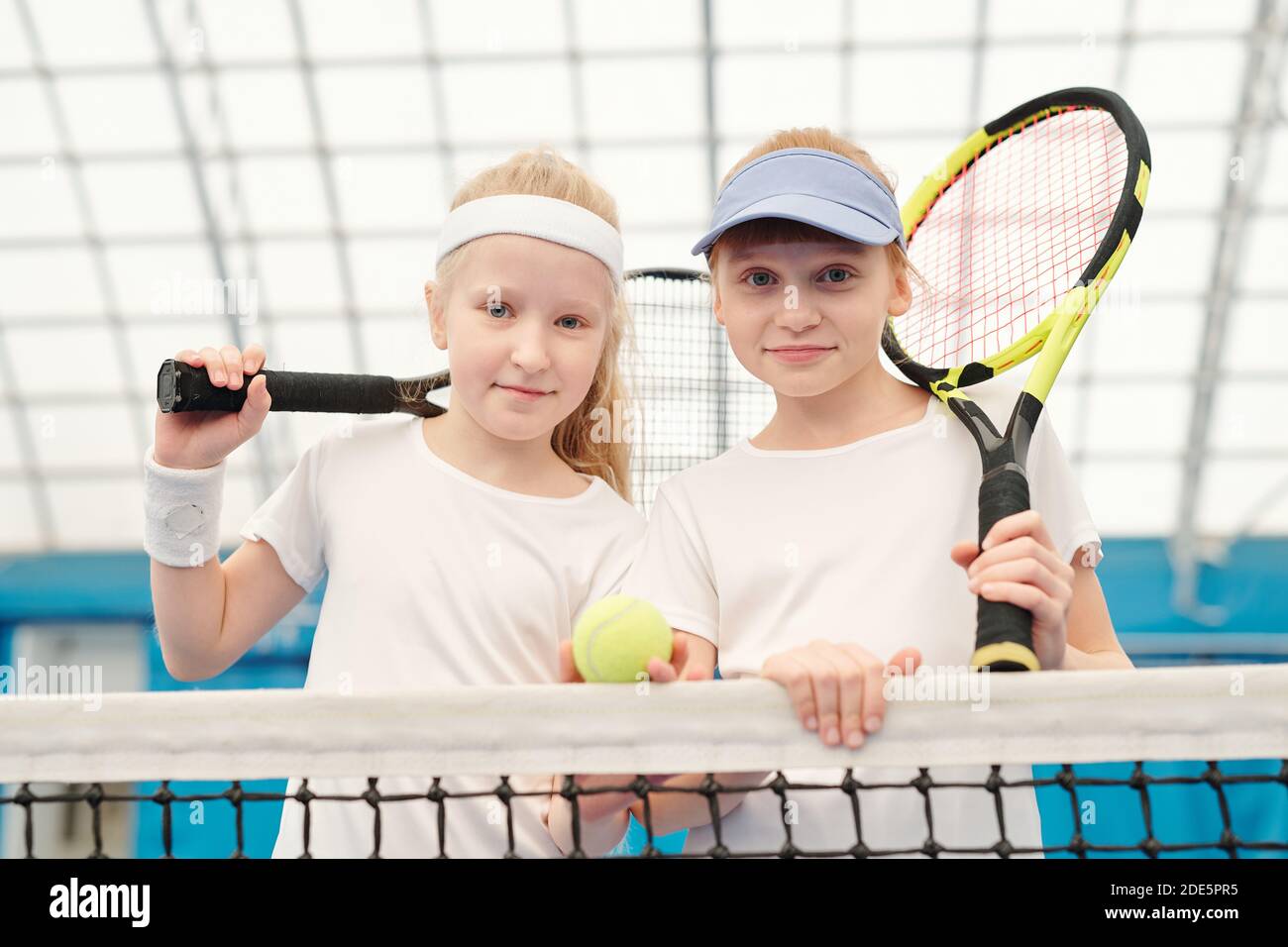 Young girls holding tennis rackets hi-res stock photography and images ...