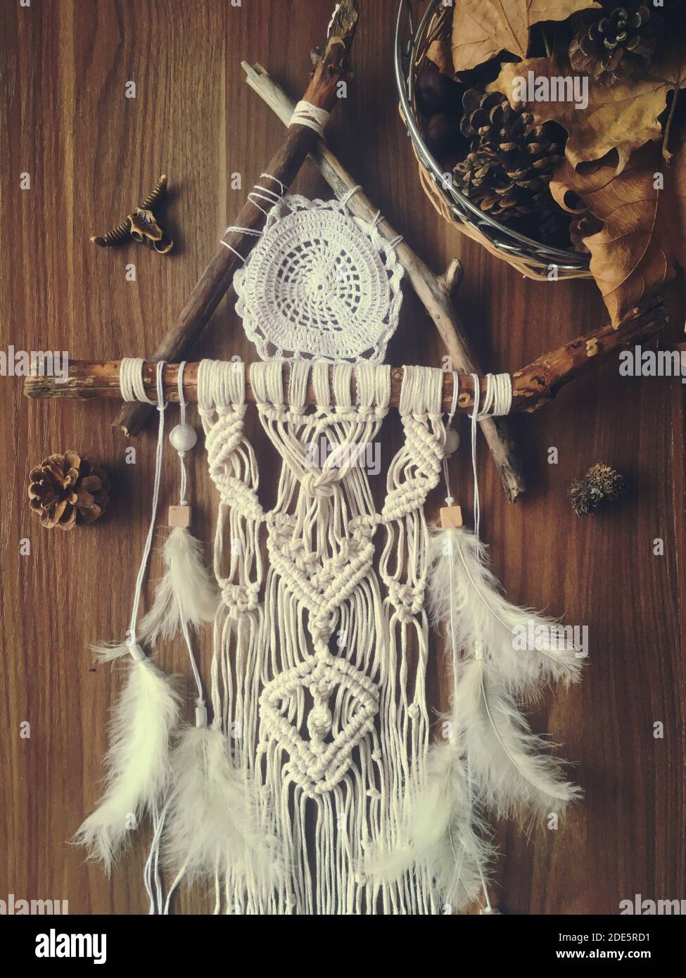 Handmade Macrame wall hanging white color with feathers Stock Photo - Alamy