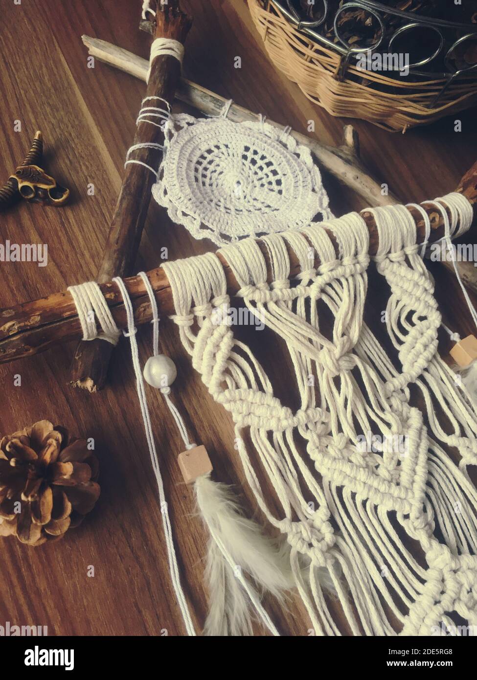 Handmade Macrame wall hanging white color with feathers Stock Photo - Alamy