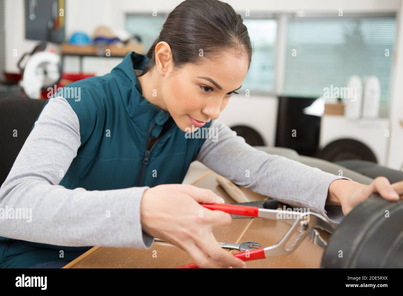 young happy cheerful positive smiling female fixing wheels Stock Photo ...