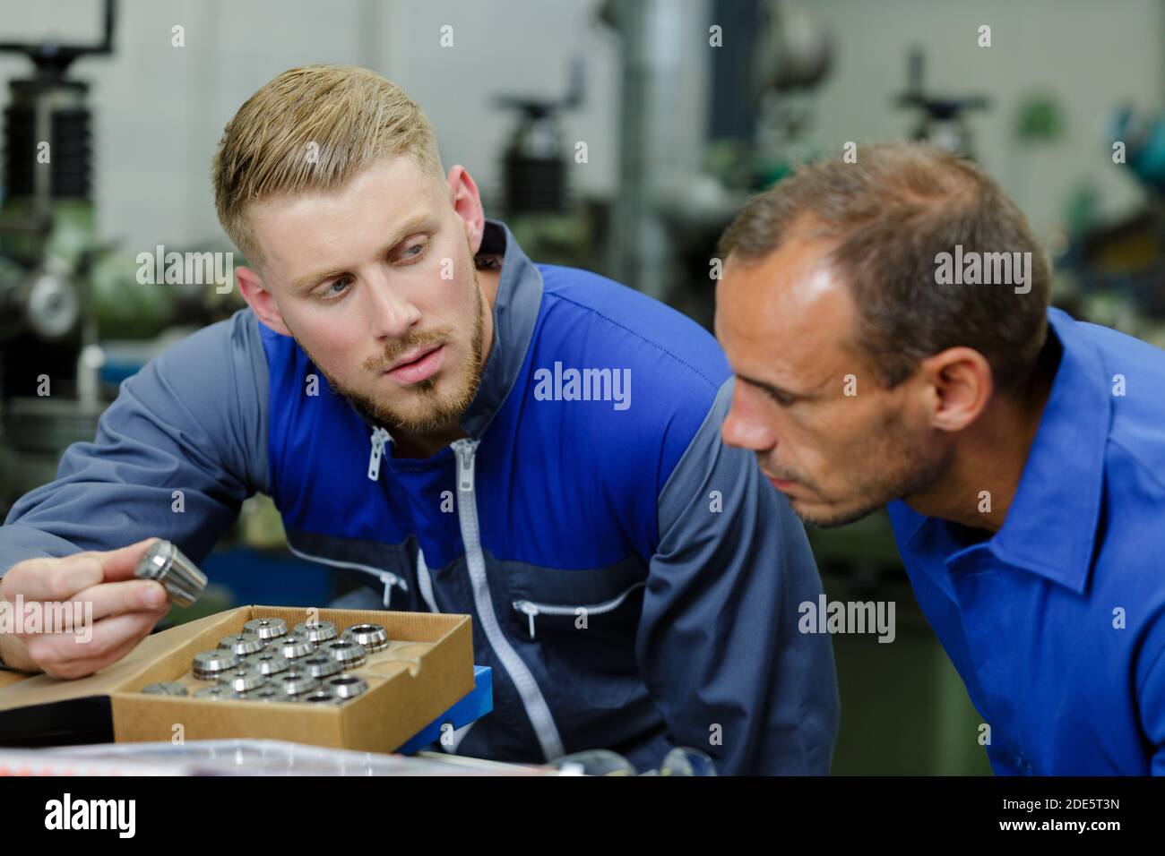 mechanics at repair shop working on a car engine Stock Photo - Alamy