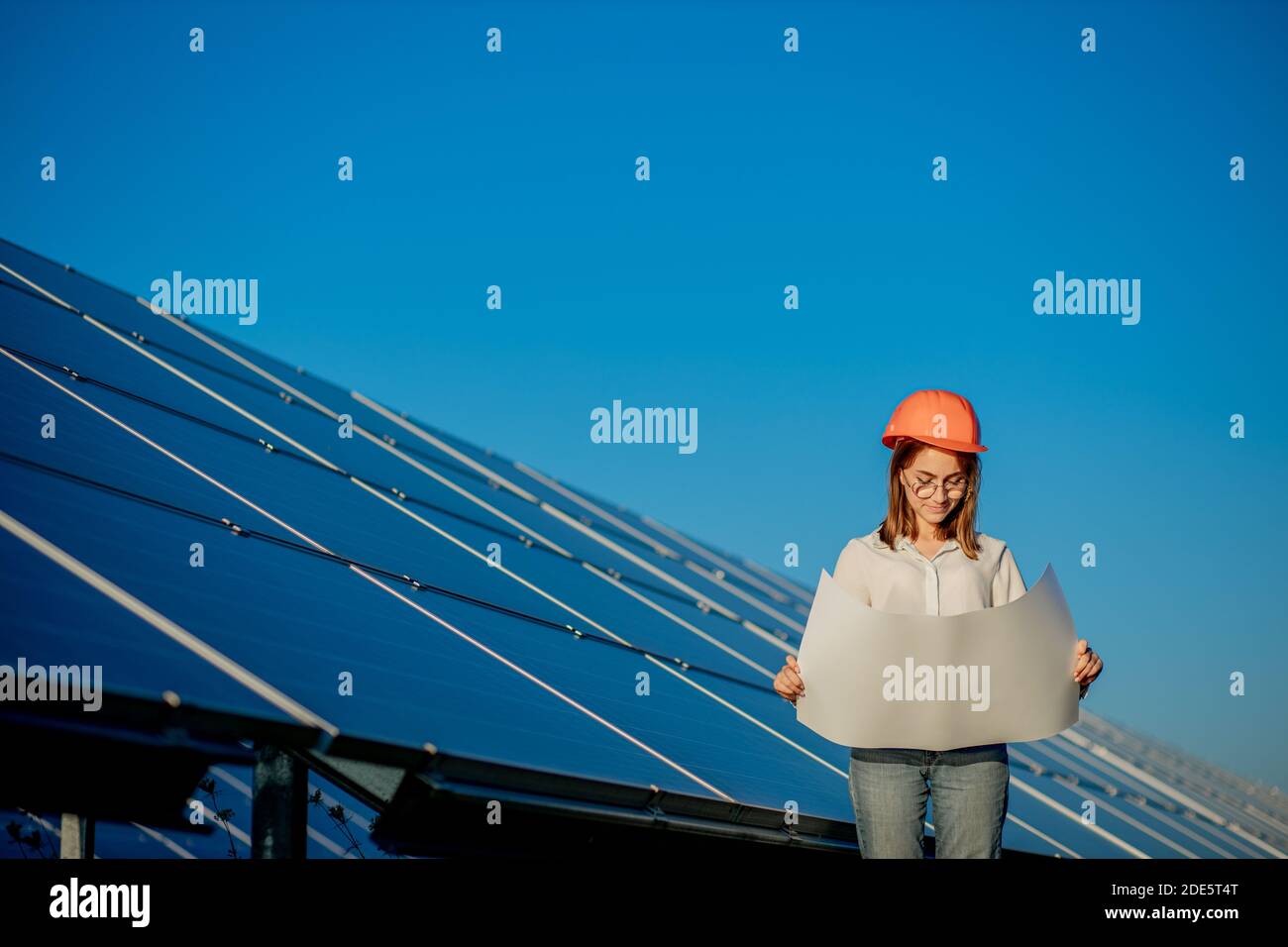 Handsome Architect Woman Examining a Draft Map or Blueprint Project ...