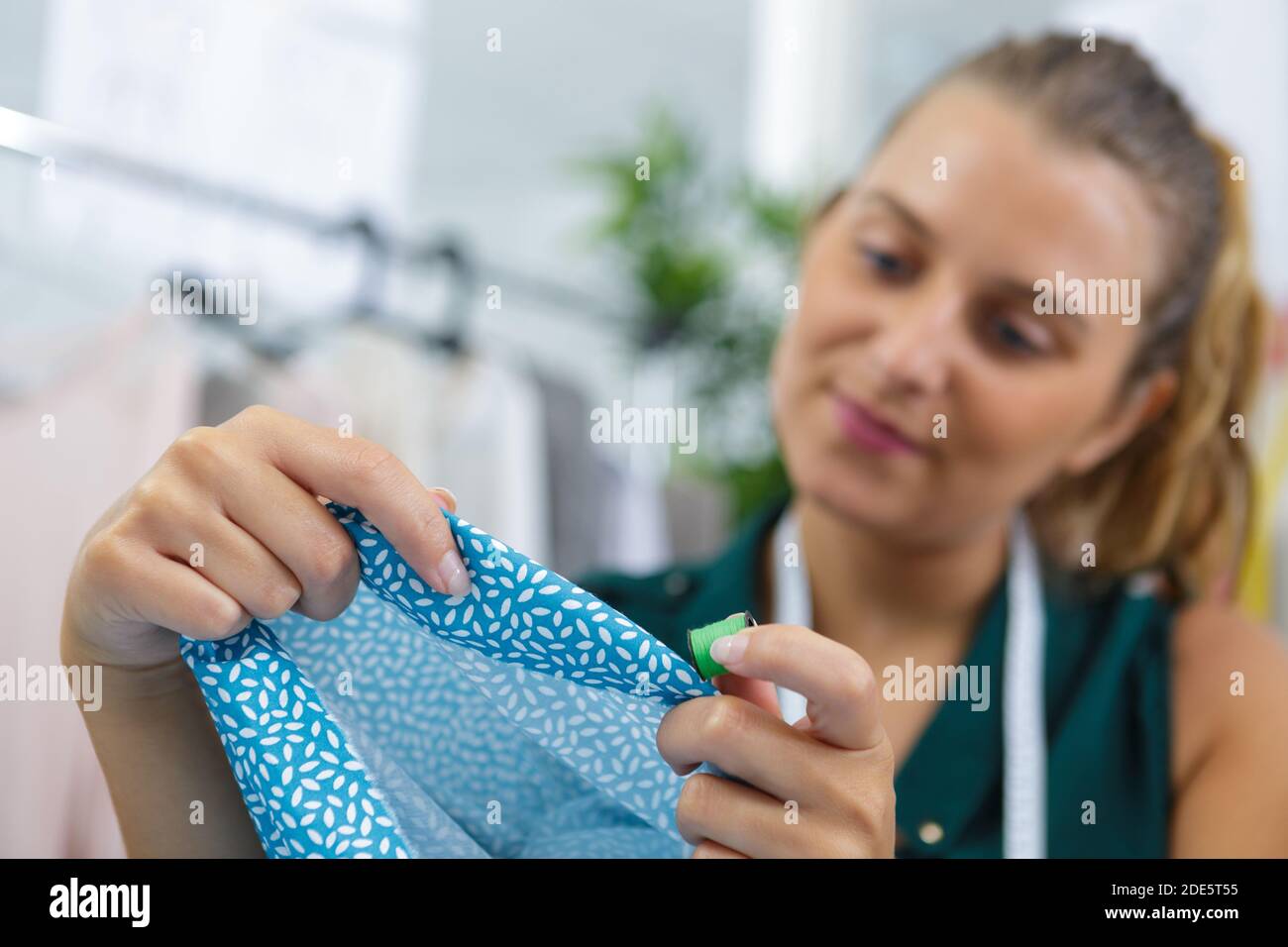 female seller looking at fabric cloth Stock Photo - Alamy