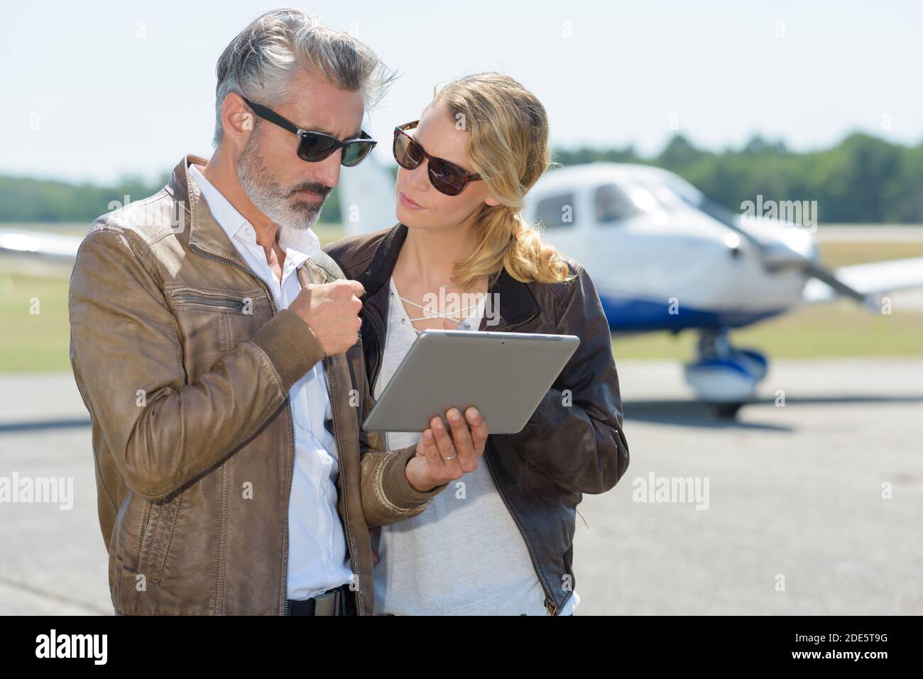 using a tablet remote control Stock Photo - Alamy