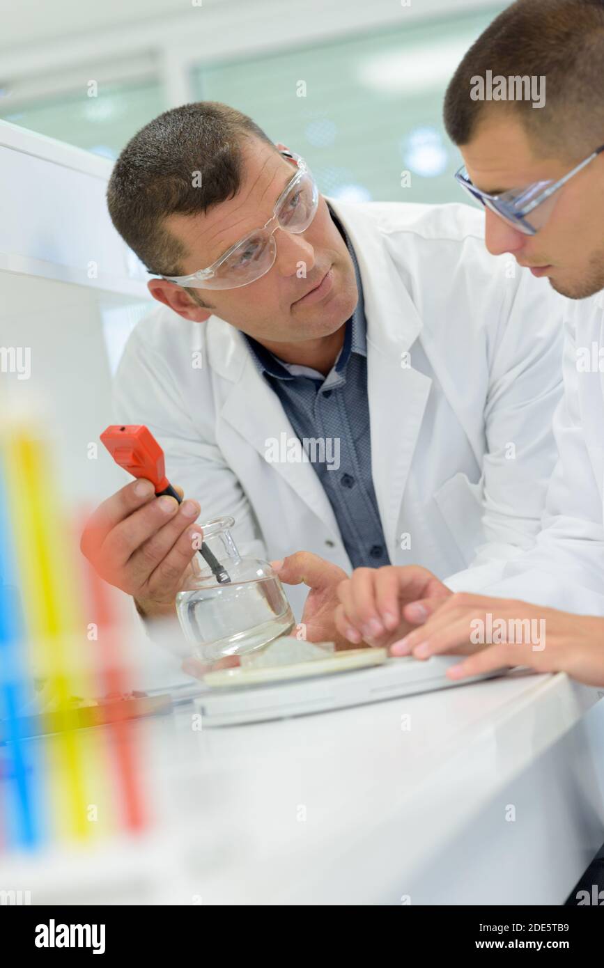 science teacher with students in lab Stock Photo - Alamy