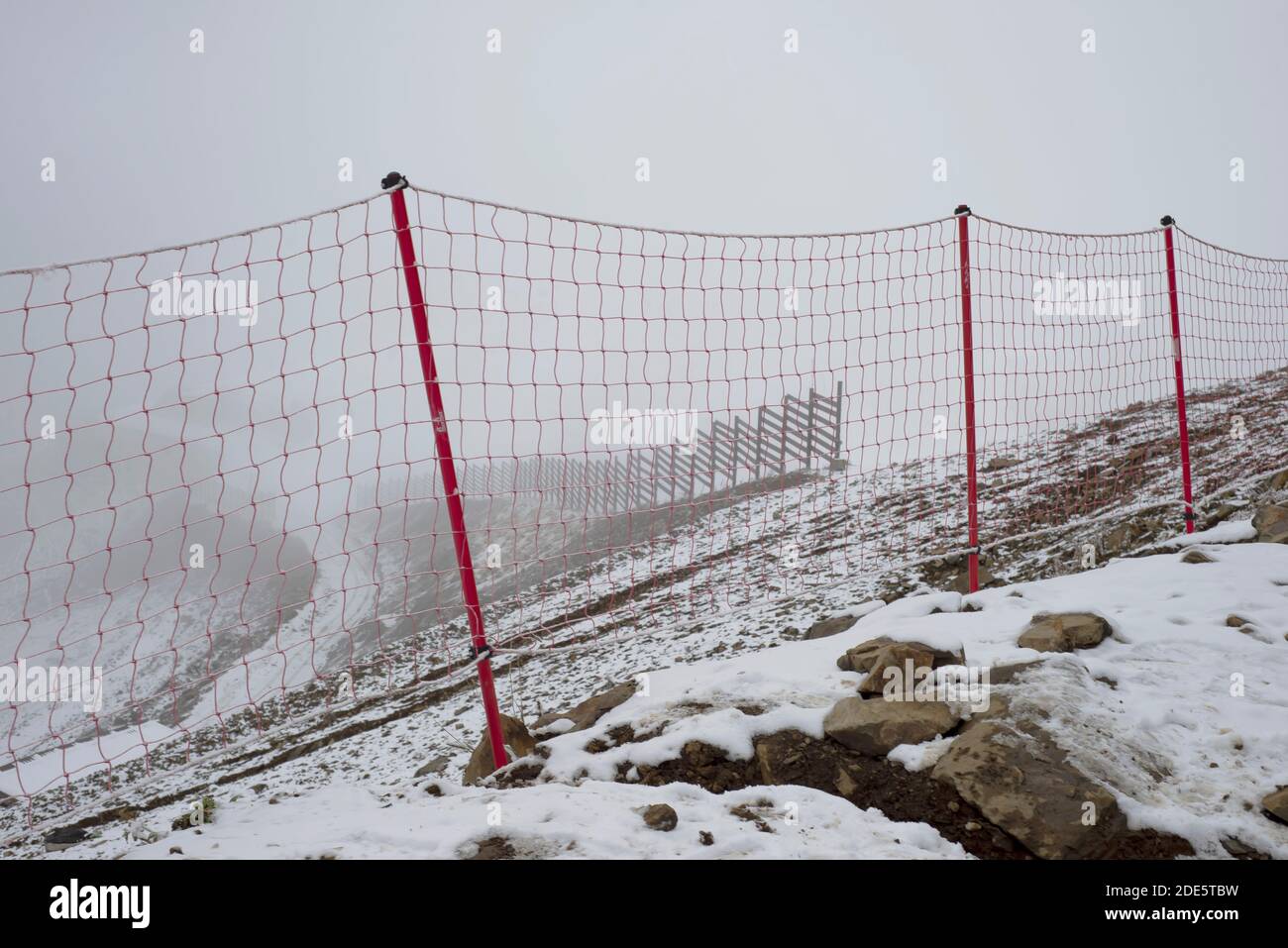 Red mesh in the mountains. Restriction in the snowy mountains. Low ...