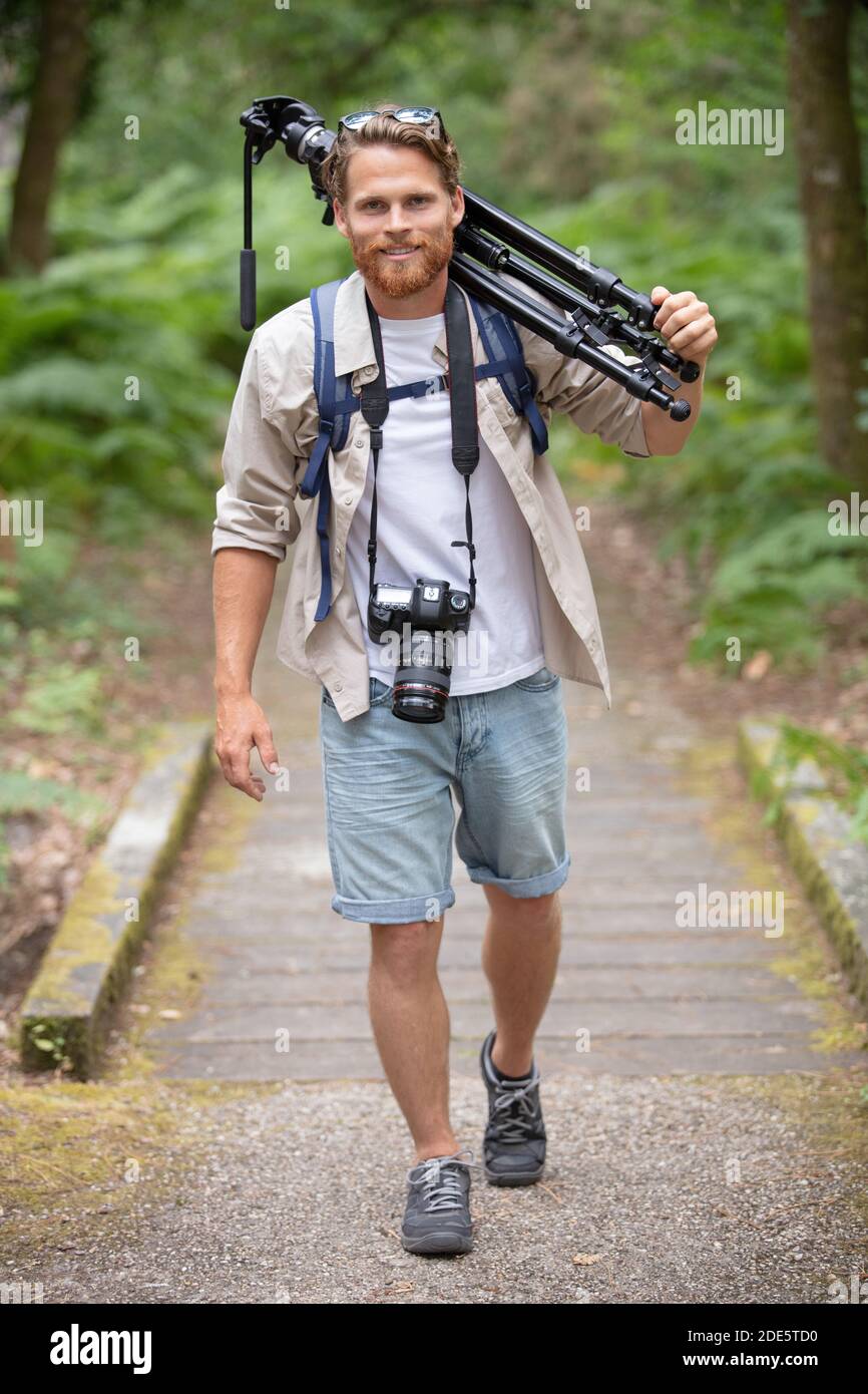 young photographer man back walking on trail path road Stock Photo - Alamy