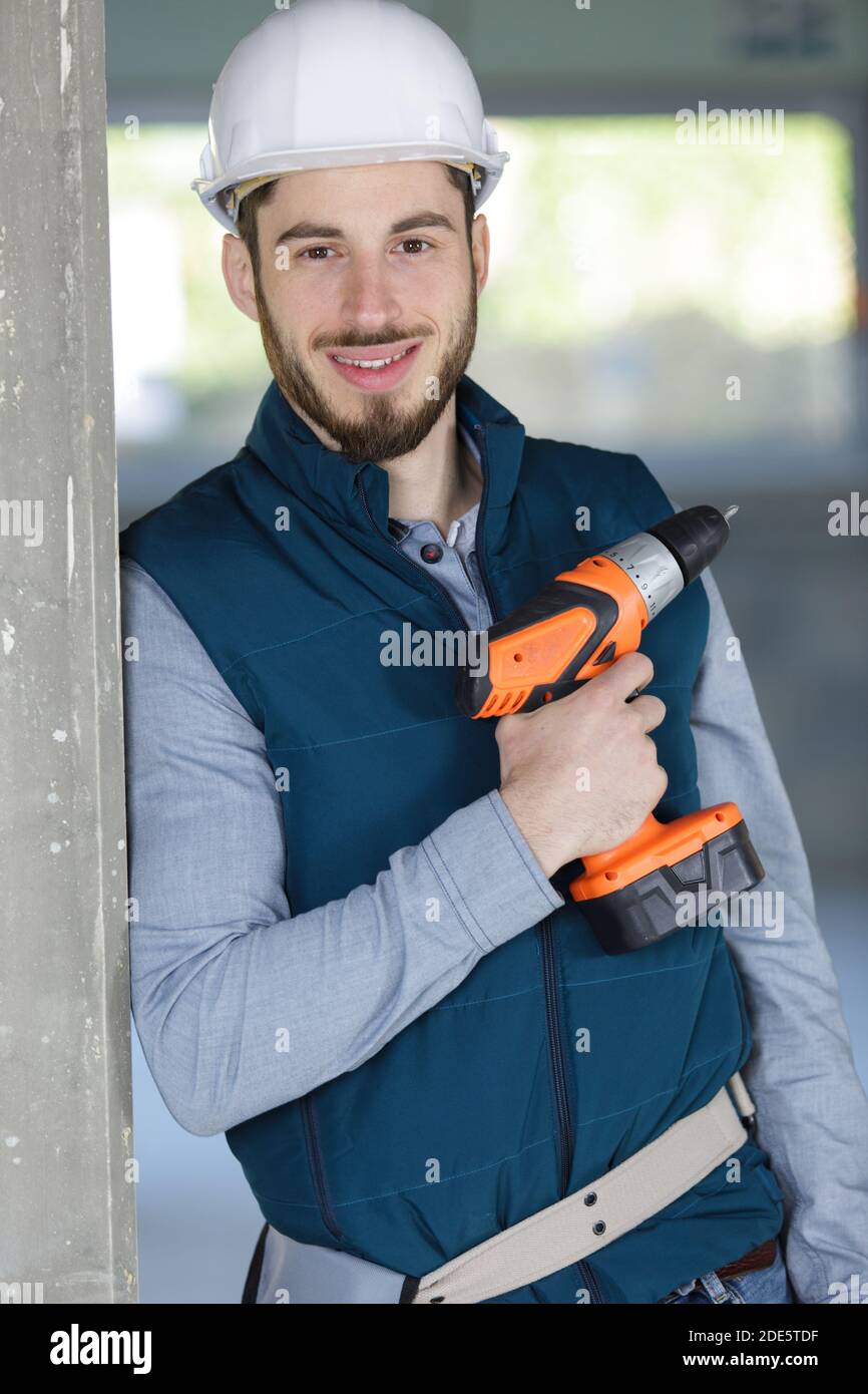 portrait of young hardworking man with drill Stock Photo - Alamy